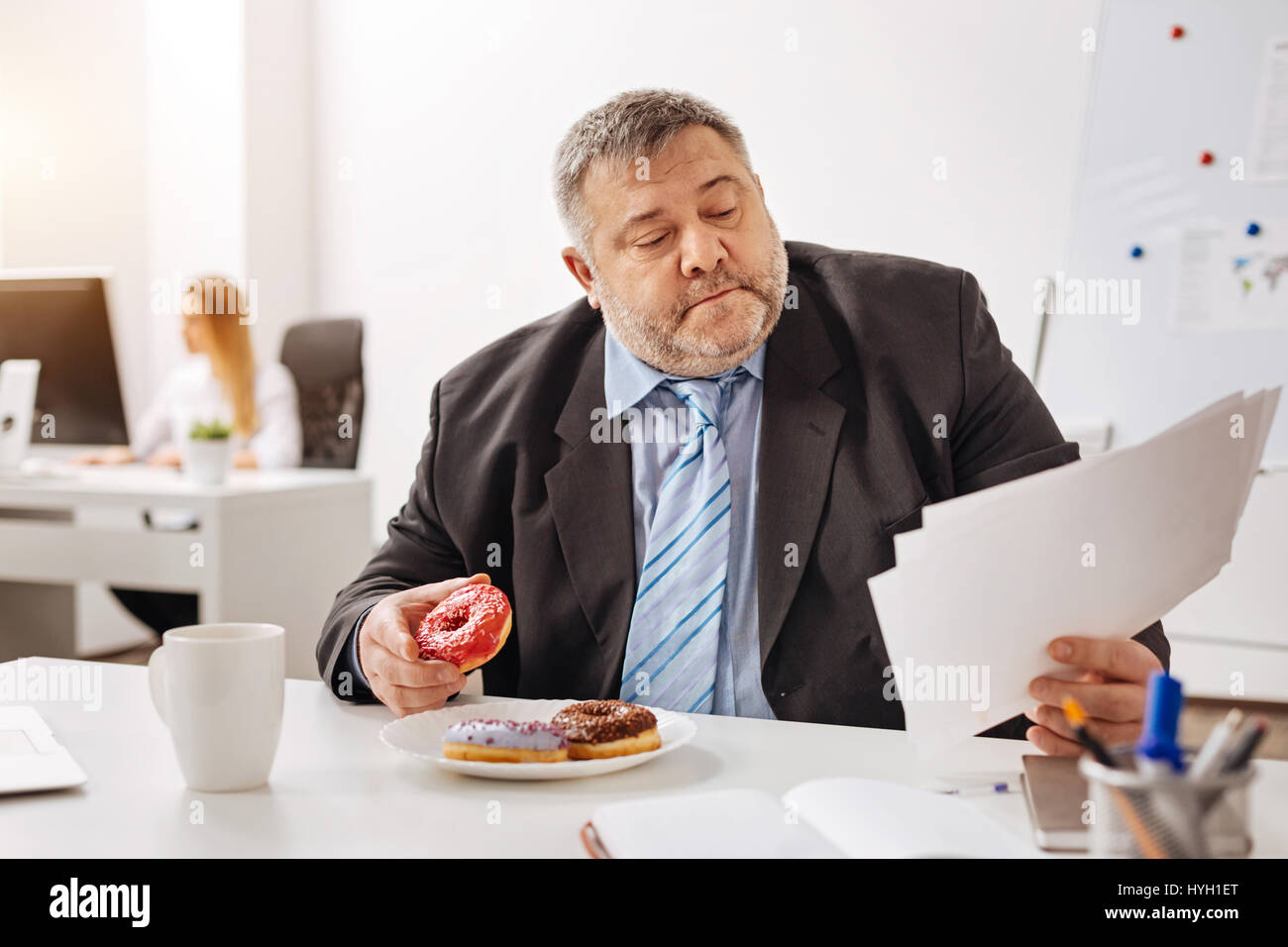 Busy engaged employee eating at his workplace Stock Photo - Alamy