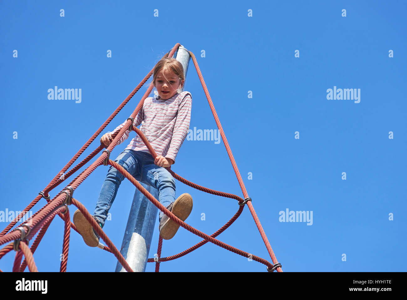 Active young child girl climbing the spider web playground activity ...