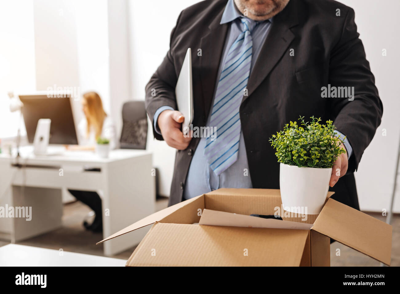 Fired average employee collecting his things Stock Photo - Alamy