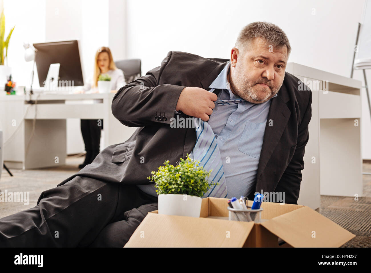 Stressed out fired employee being shocked Stock Photo - Alamy