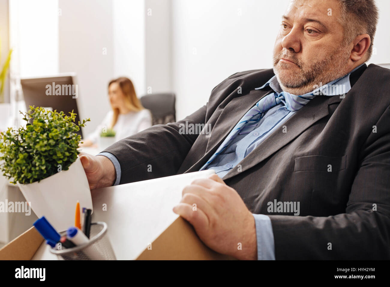 Middle aged overweight worker being dismissed Stock Photo - Alamy