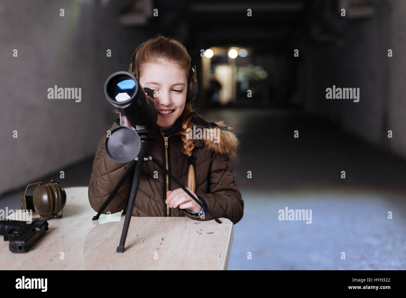 Delighted pretty girl using the telescope Stock Photo - Alamy