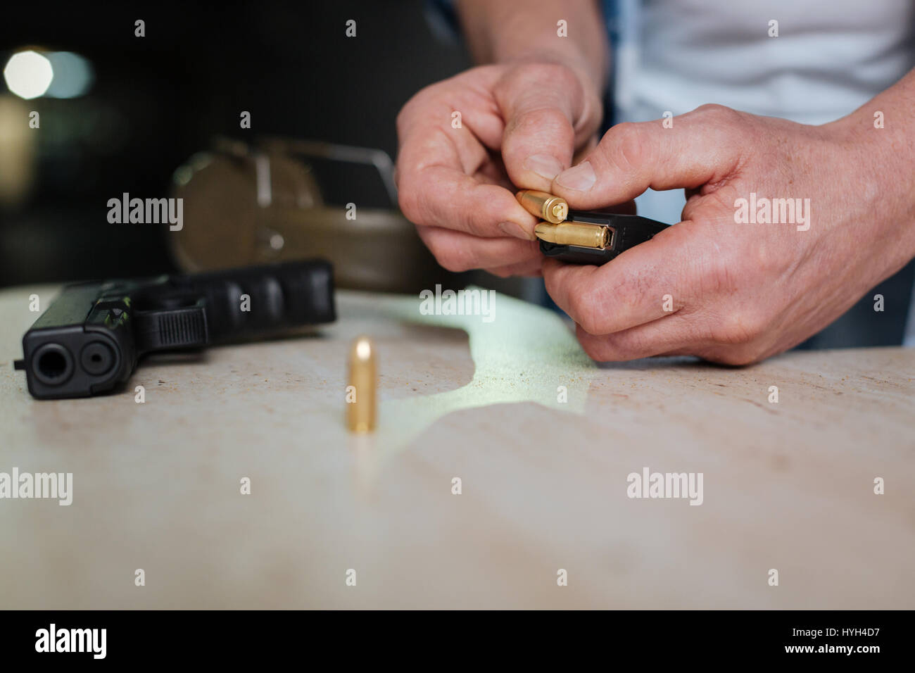 Metal handgun bullet being in hands of a man Stock Photo - Alamy