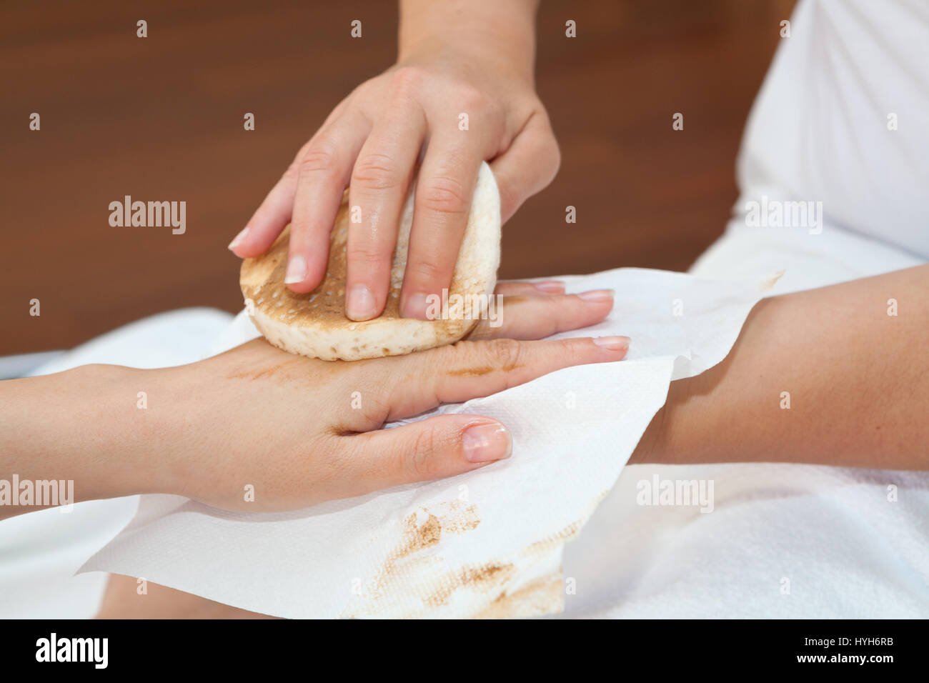 Therapist removing skin mask from the client's hand Stock Photo - Alamy