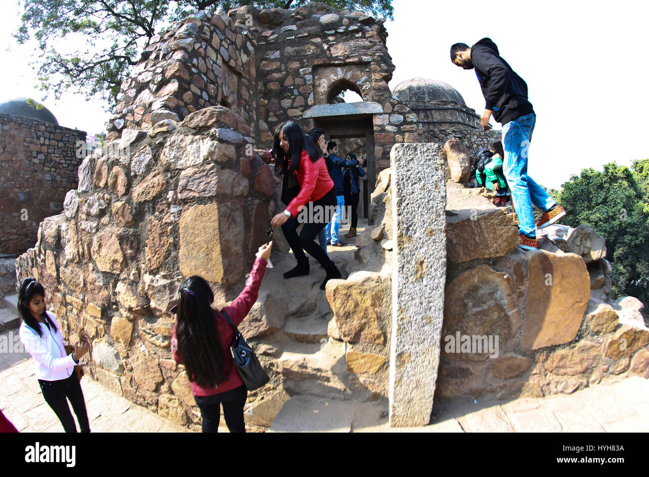 people climbing the Hauz Khas Fort, assembly hall of the 14th century ...