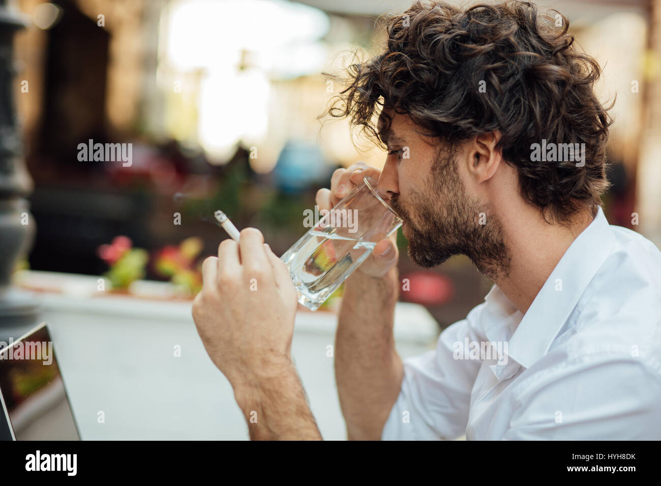 Handsome man smoking sitting hi-res stock photography and images - Alamy