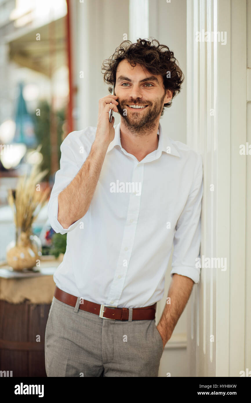 Stylish young man standing chair hi-res stock photography and images ...