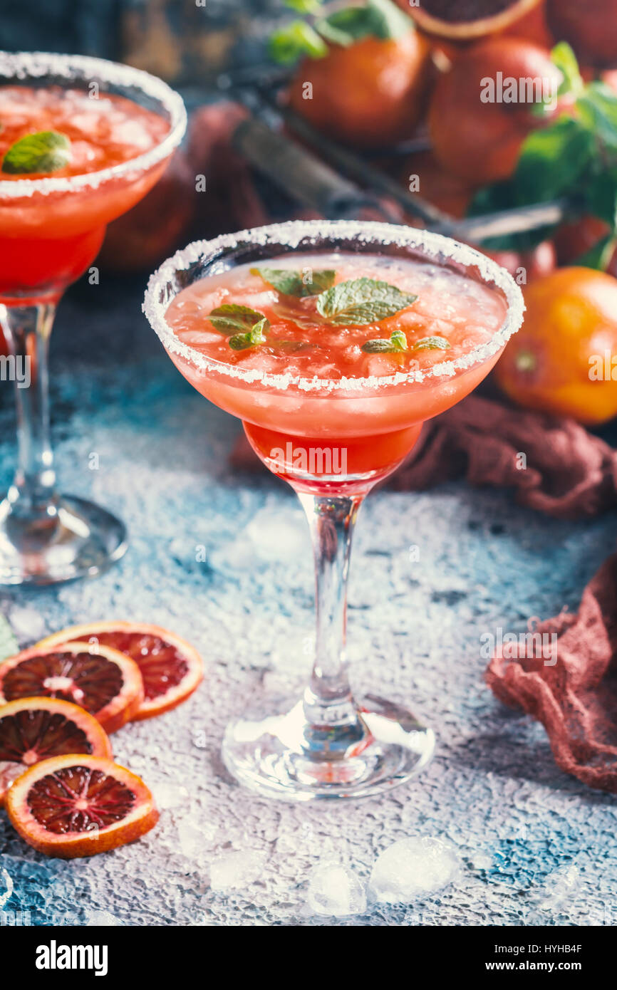 Blood Orange Margarita cocktail with mint and red orange in salt rimmed ...