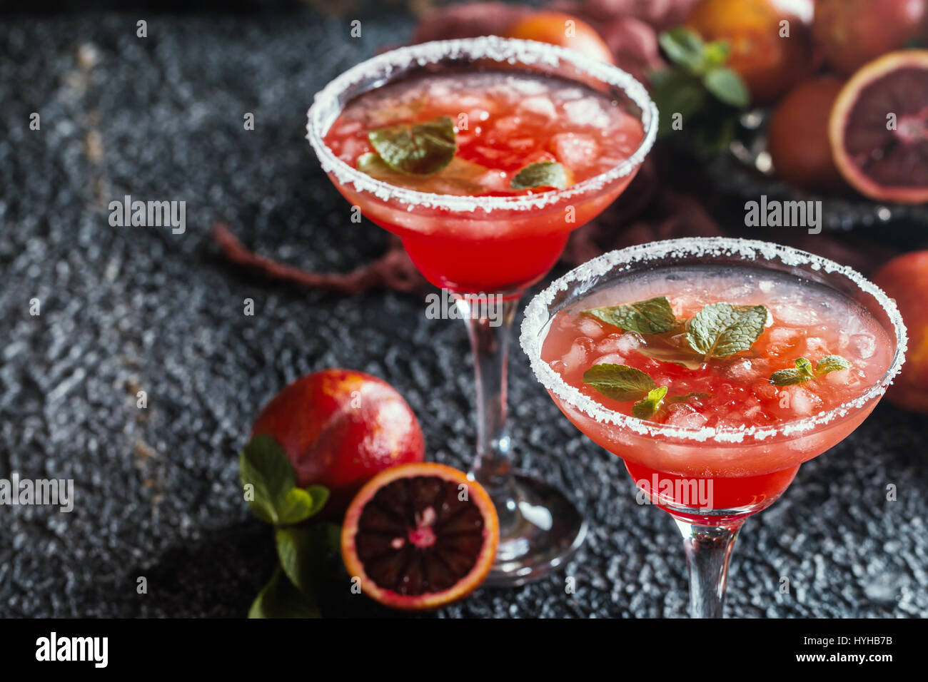 Blood Orange Margarita cocktail with mint and red orange in salt rimmed ...