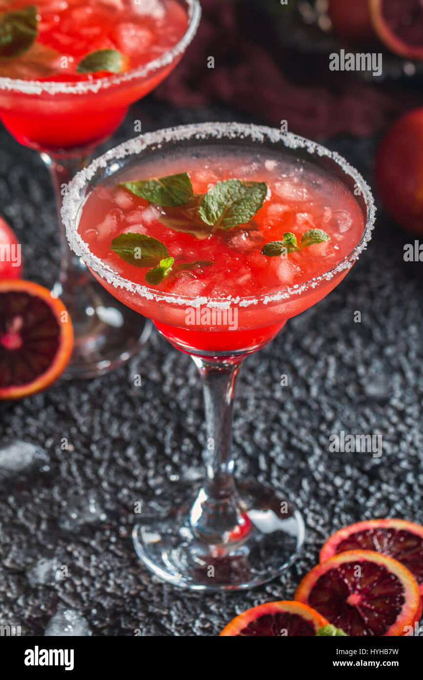 Blood Orange Margarita cocktail with mint and red orange in salt rimmed ...