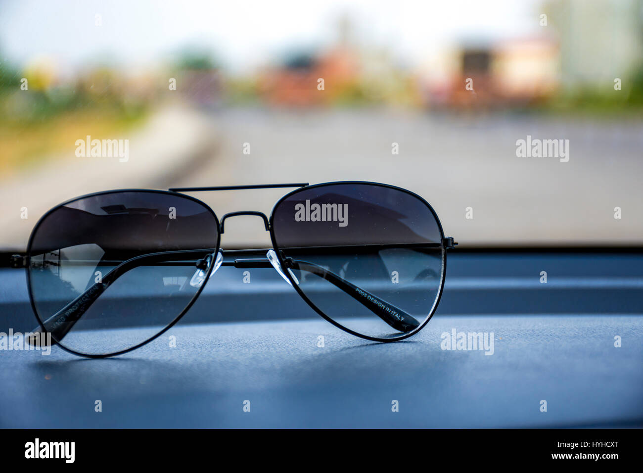 Aviator sunglasses goggle on Car desk Stock Photo - Alamy