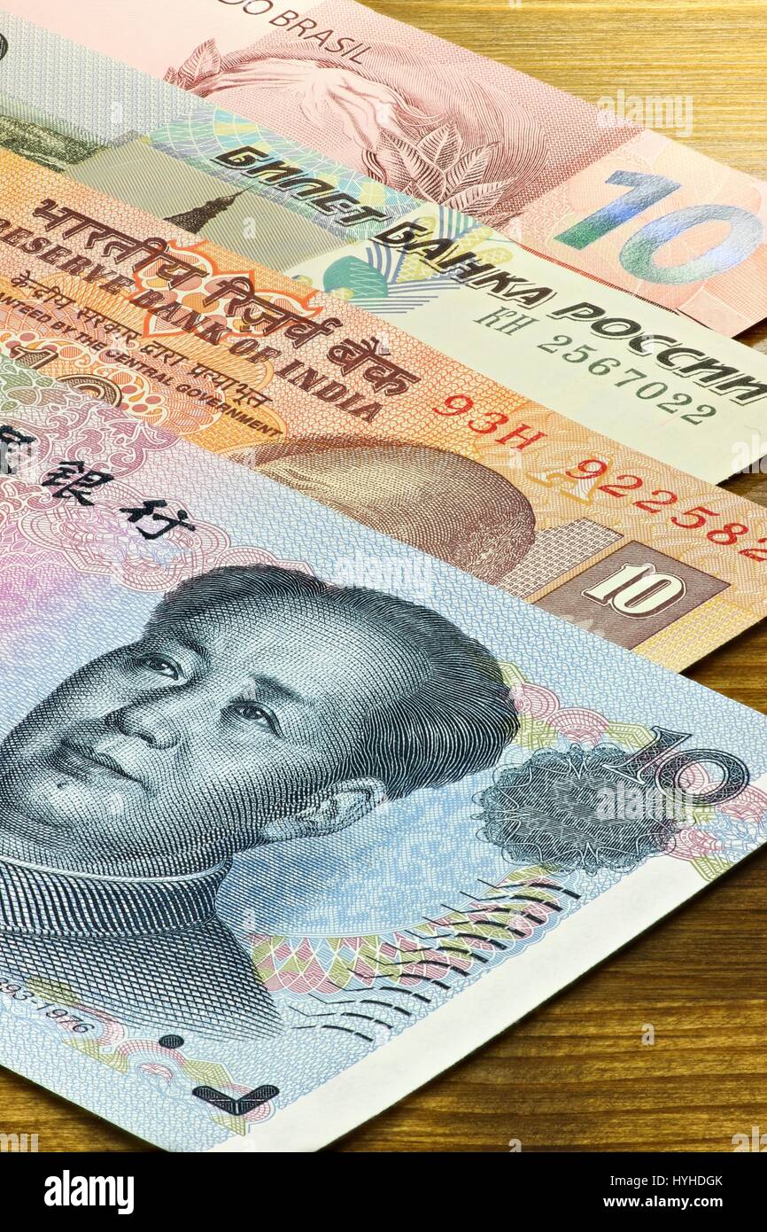 banknotes of the BRIC states on wooden background Stock Photo - Alamy