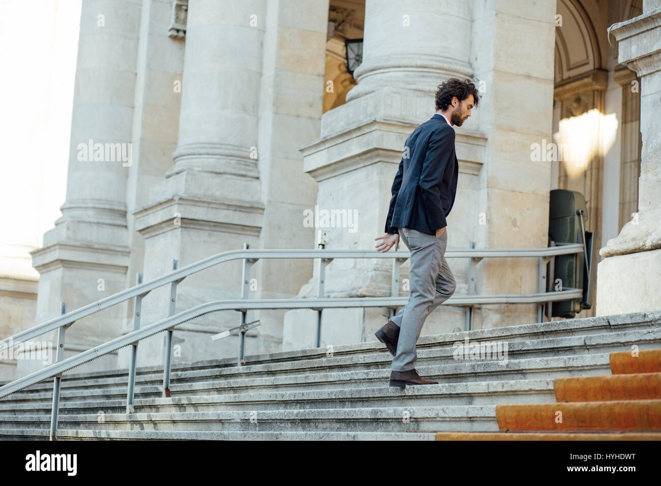 Man climbing stairs hi-res stock photography and images - Alamy