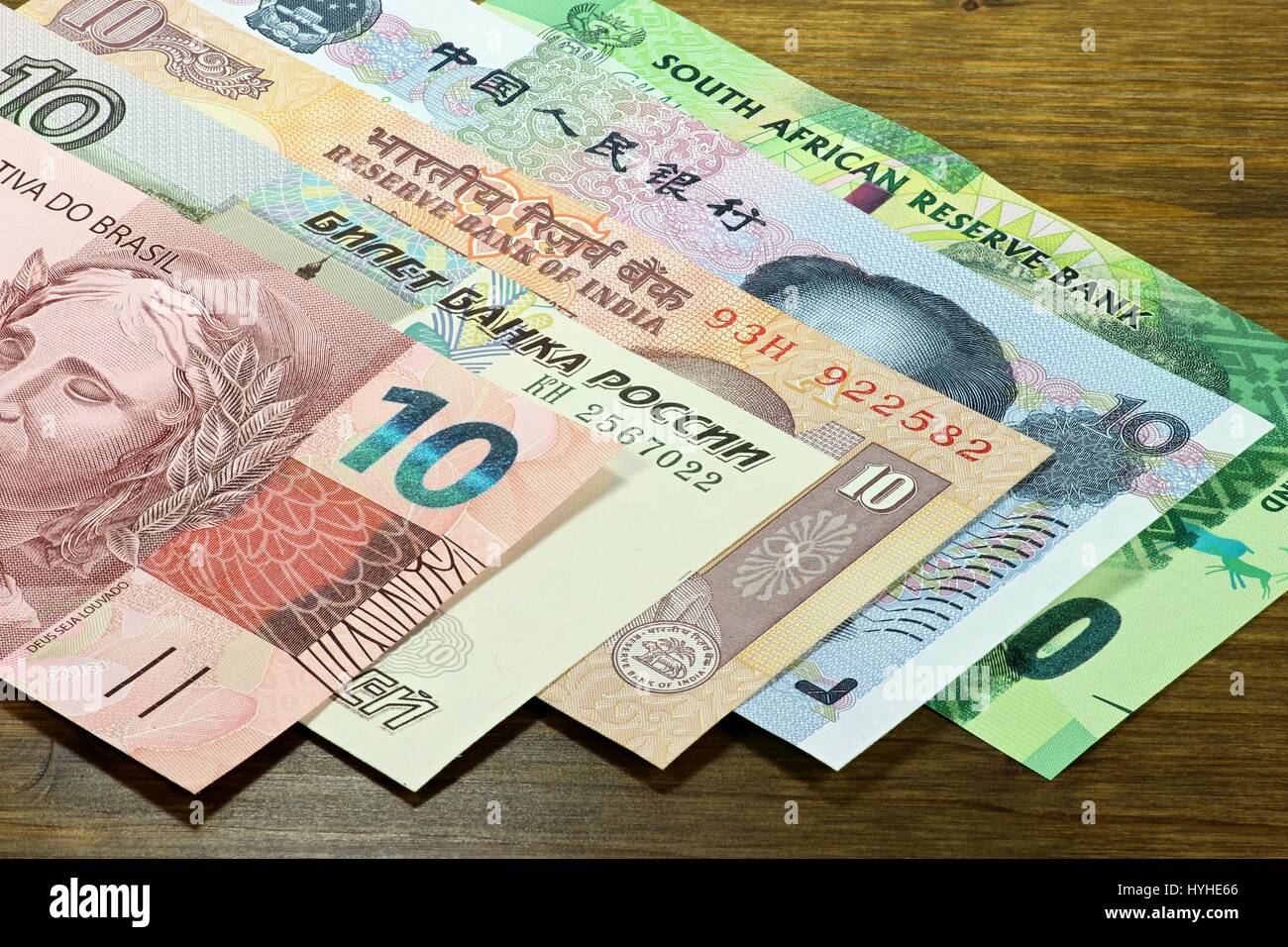 banknotes of the BRICS states on wooden background Stock Photo - Alamy