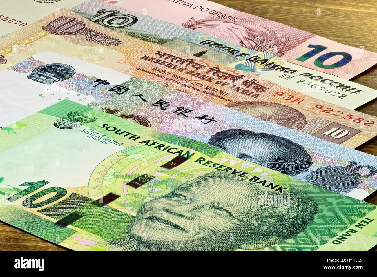 banknotes of the BRICS states on wooden background Stock Photo - Alamy