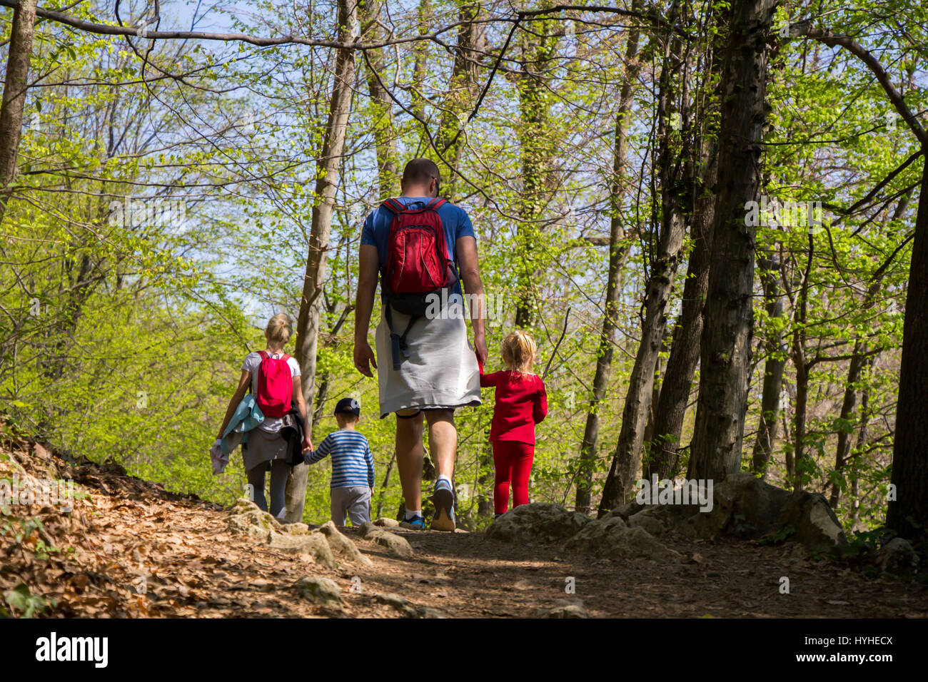 Parents with children walking by hiking trail Stock Photo - Alamy