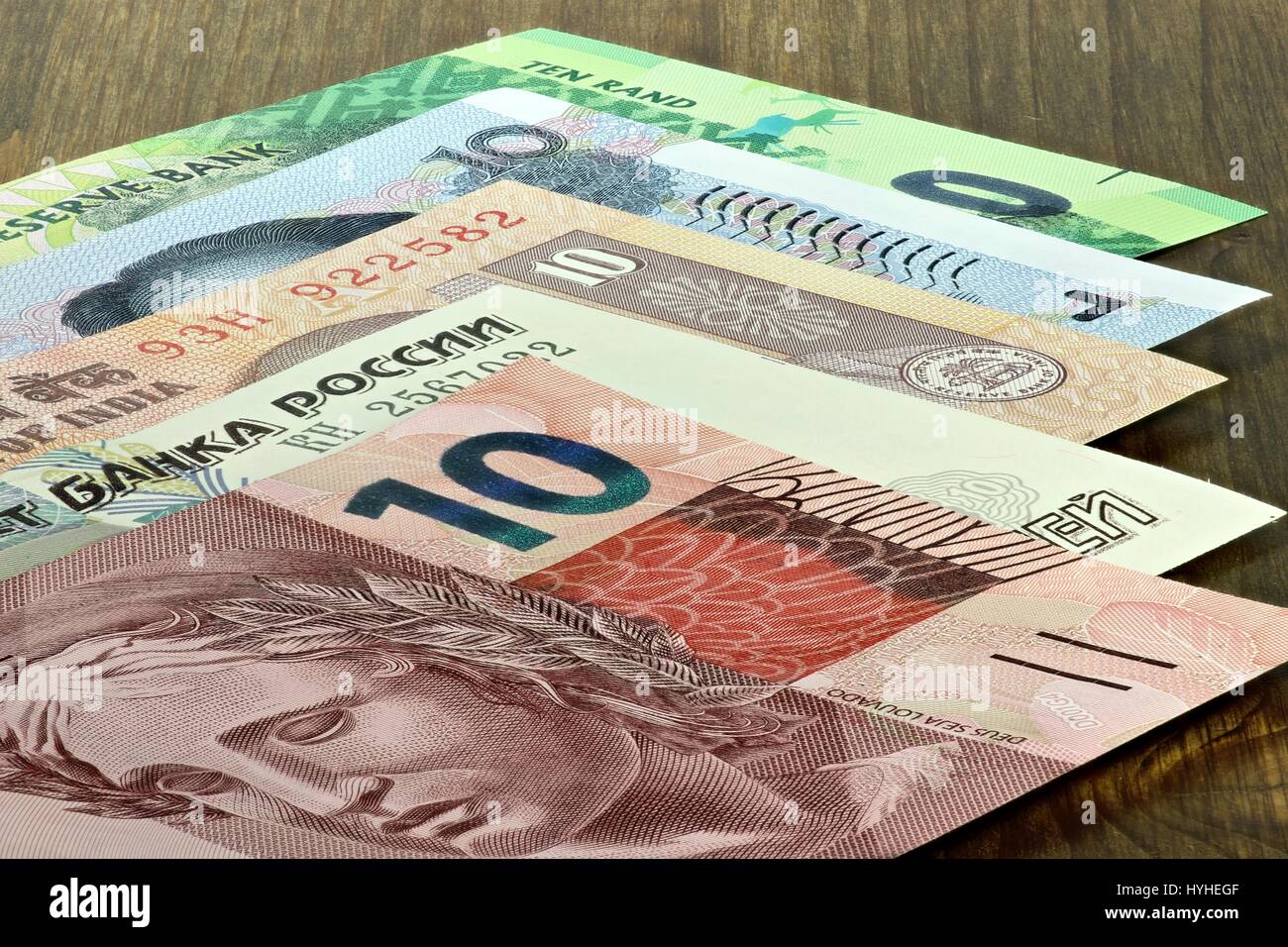 banknotes of the BRICS states on wooden background Stock Photo - Alamy