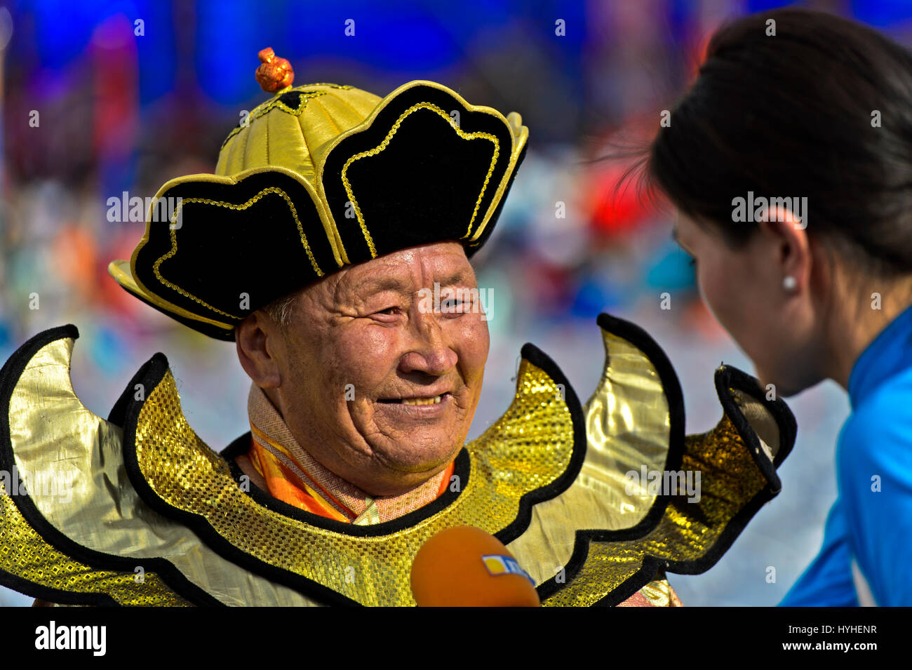 Mongolian man in traditional deel dress giving an interview to a ...