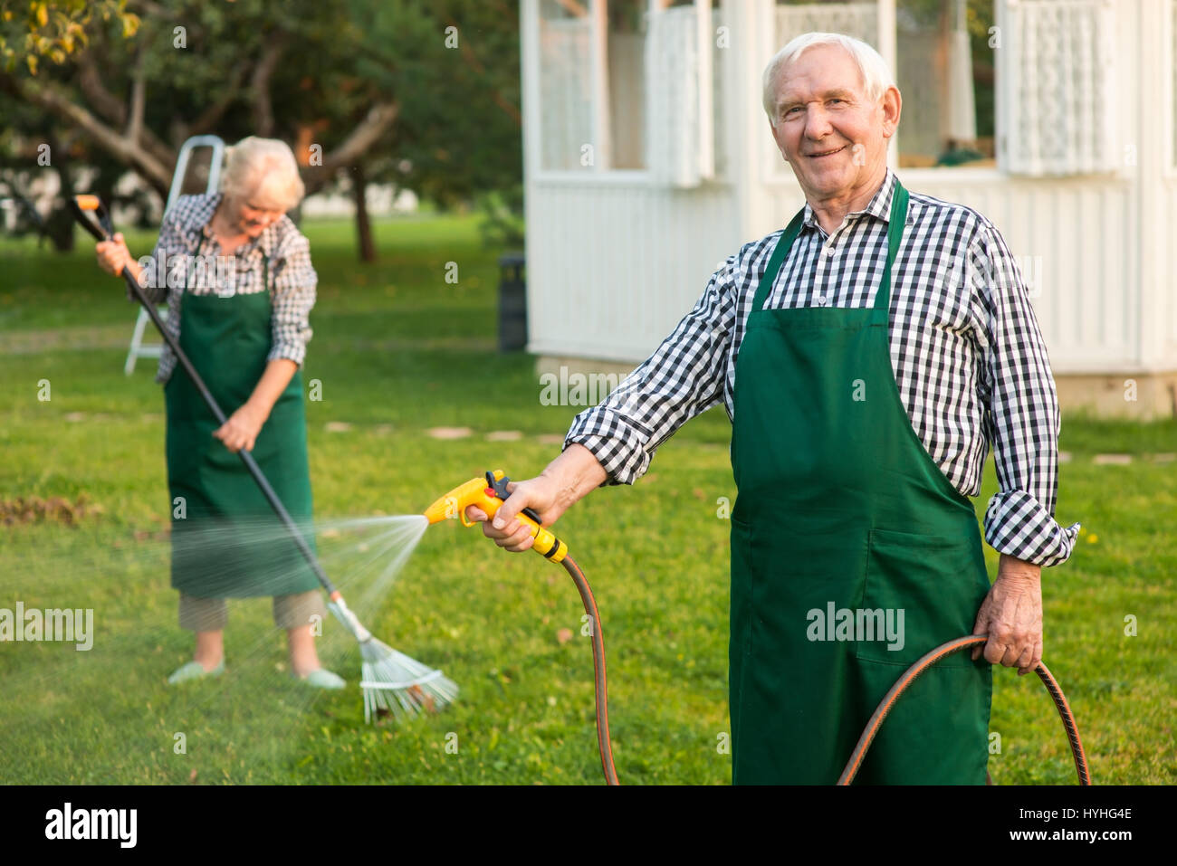 Man with hose hi-res stock photography and images - Alamy