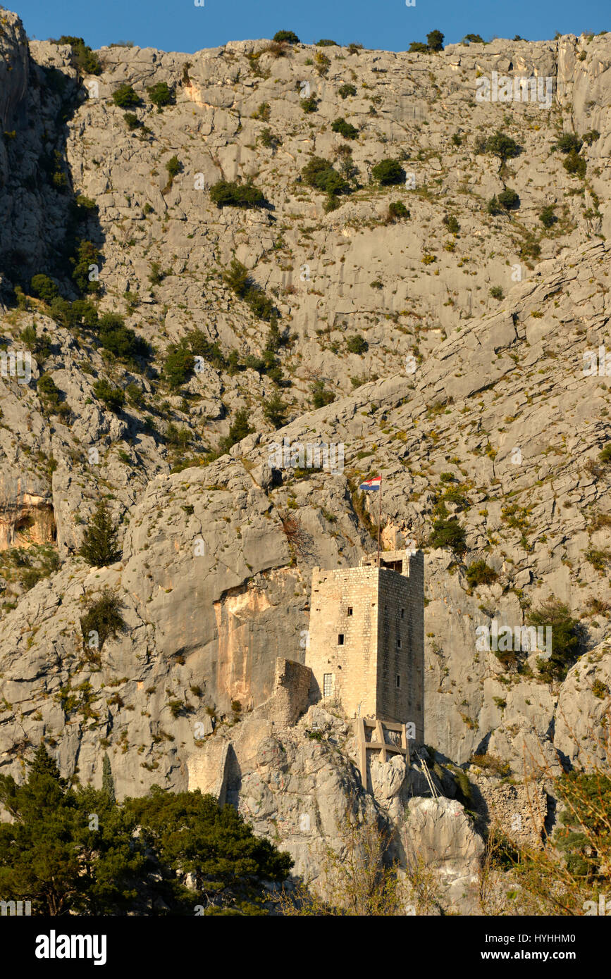 The setting sun illuminates the medieval ruins of Mirabella fortress ...