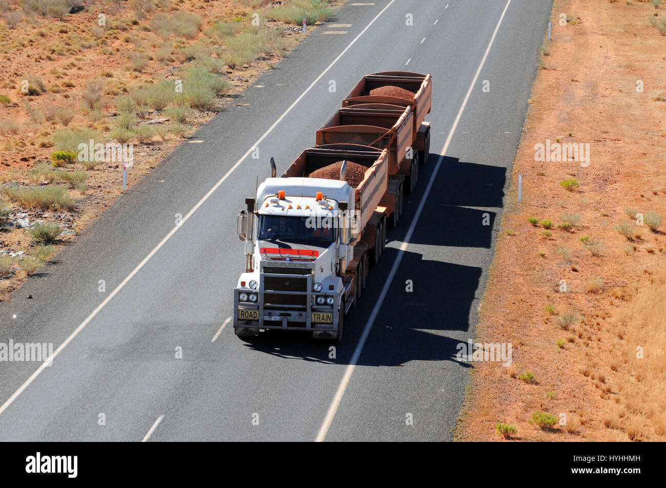 Road train carrying gravel on an outback road in Western Australia ...