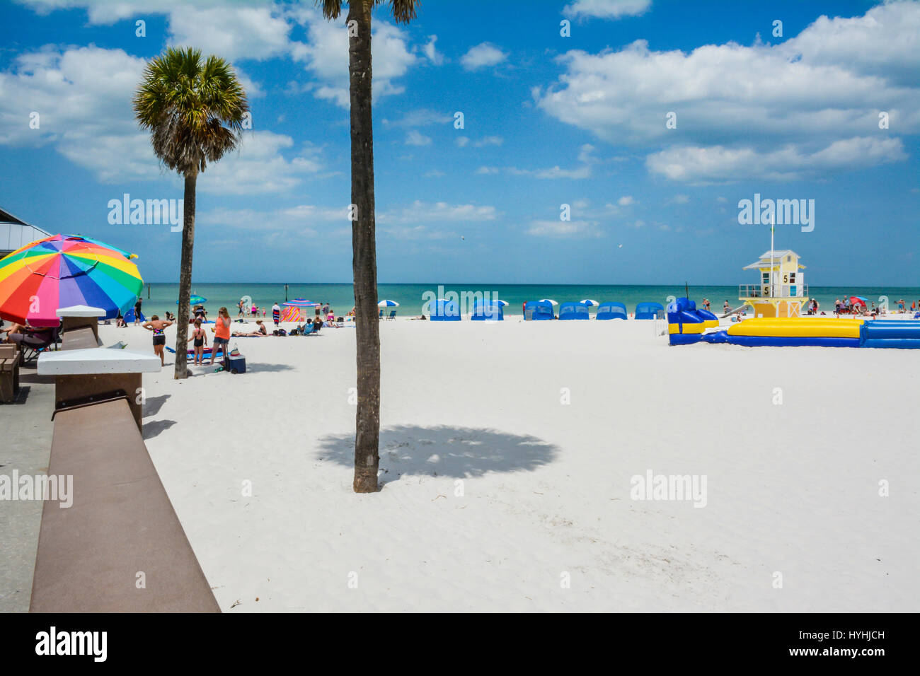 View of people enjoying the white sand and turquoise waters of ...