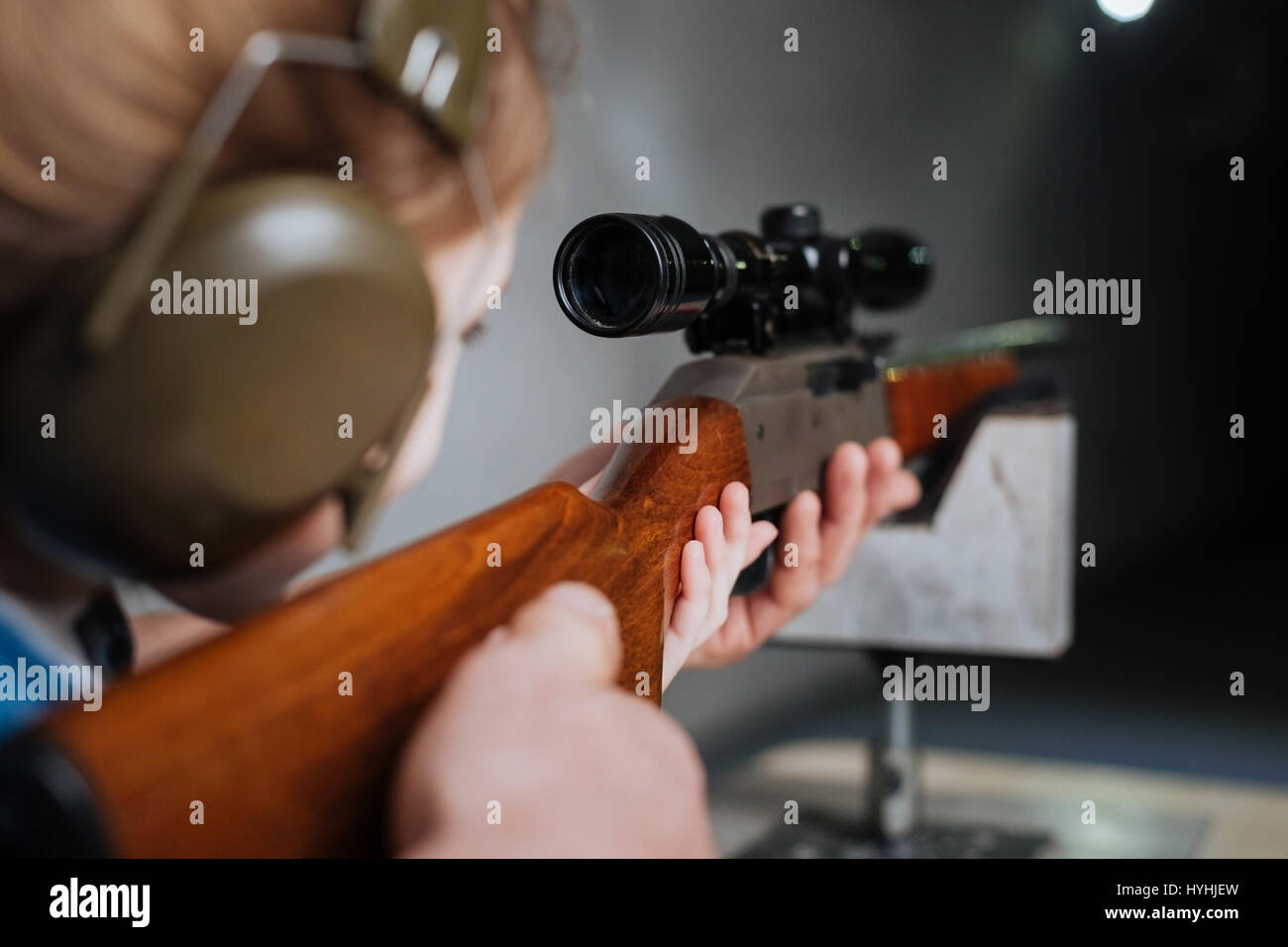 Confident pretty girl shooting at the target Stock Photo - Alamy