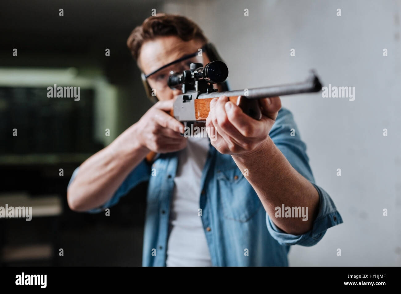 Nice pleasant man developing his shooting skills Stock Photo - Alamy