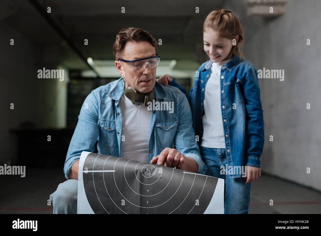 Nice handsome man pointing at the target Stock Photo - Alamy