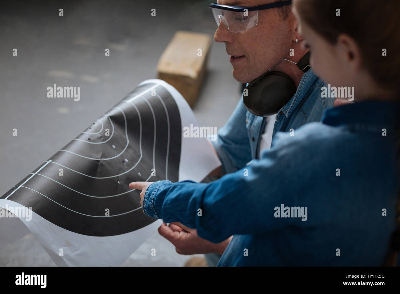 Nice cute girl pointing at the target Stock Photo - Alamy