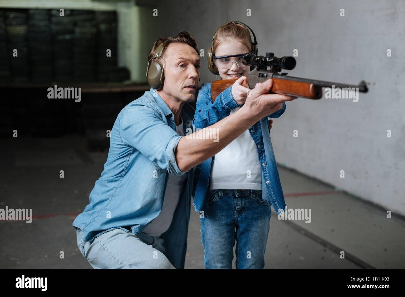 Happy delighted girl looking into the optical sight Stock Photo - Alamy