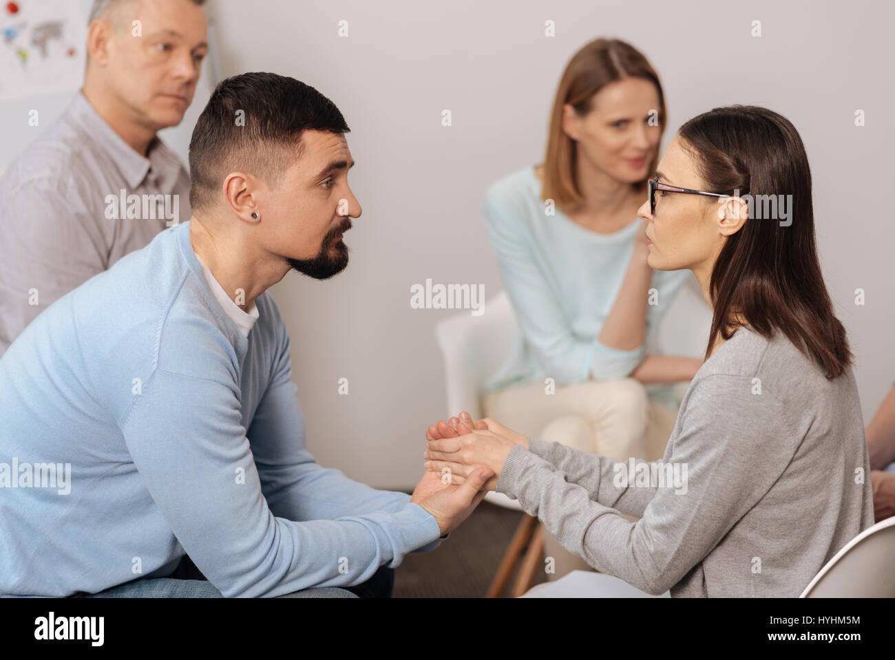 Serious man supporting his colleague Stock Photo - Alamy