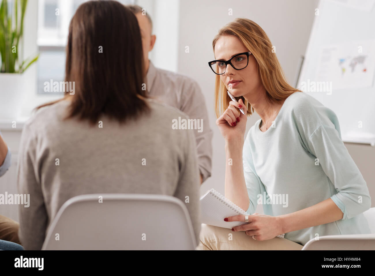 Attentive female listening to office workers Stock Photo - Alamy