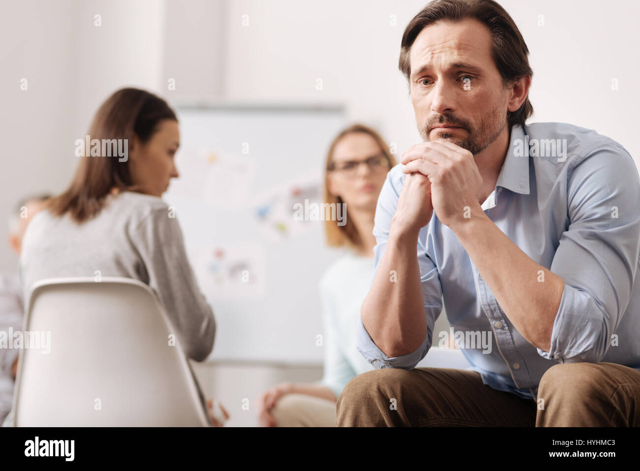 Sad male person thinking about work Stock Photo - Alamy