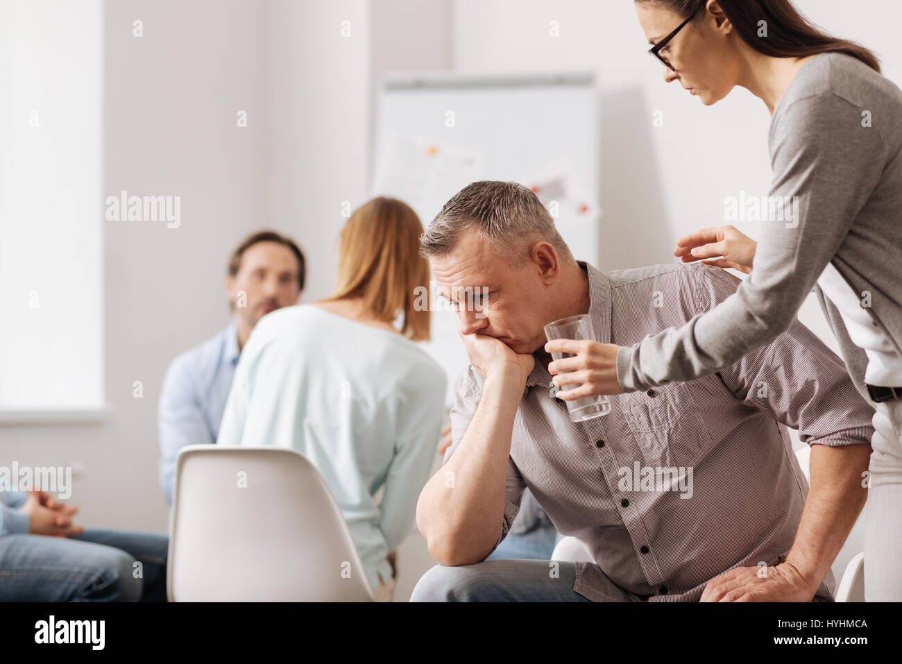 Thoughtful male leaning on his hand Stock Photo - Alamy
