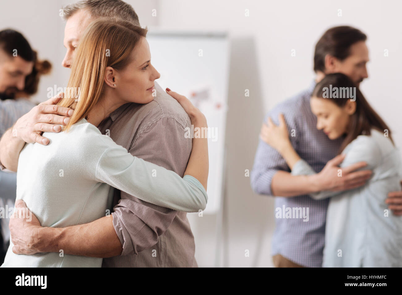 Kind female clasping her partner Stock Photo - Alamy