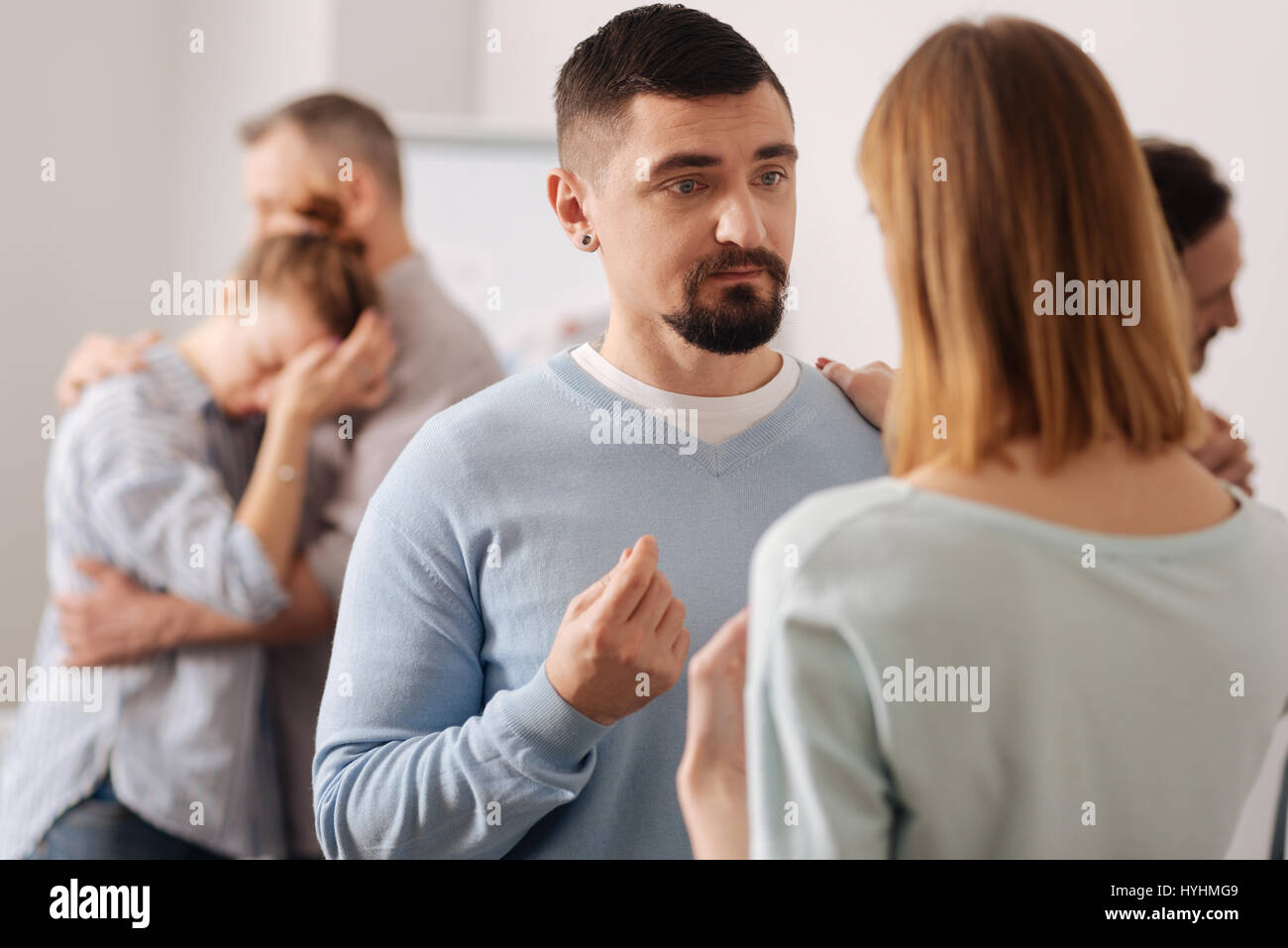Very attentive male person listening to his coworker Stock Photo - Alamy