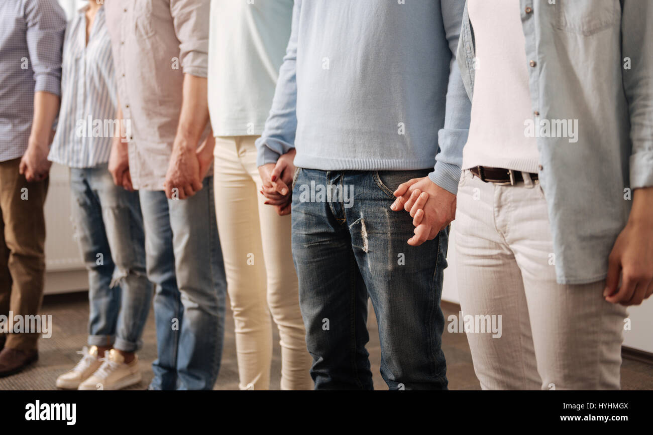 Close up of coworkers standing in one line Stock Photo - Alamy
