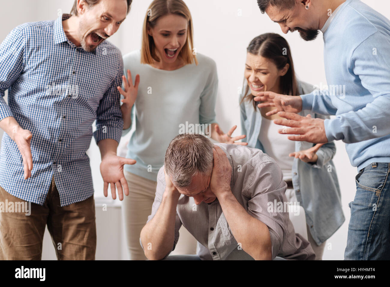 Young colleagues shouting at their coworker Stock Photo - Alamy