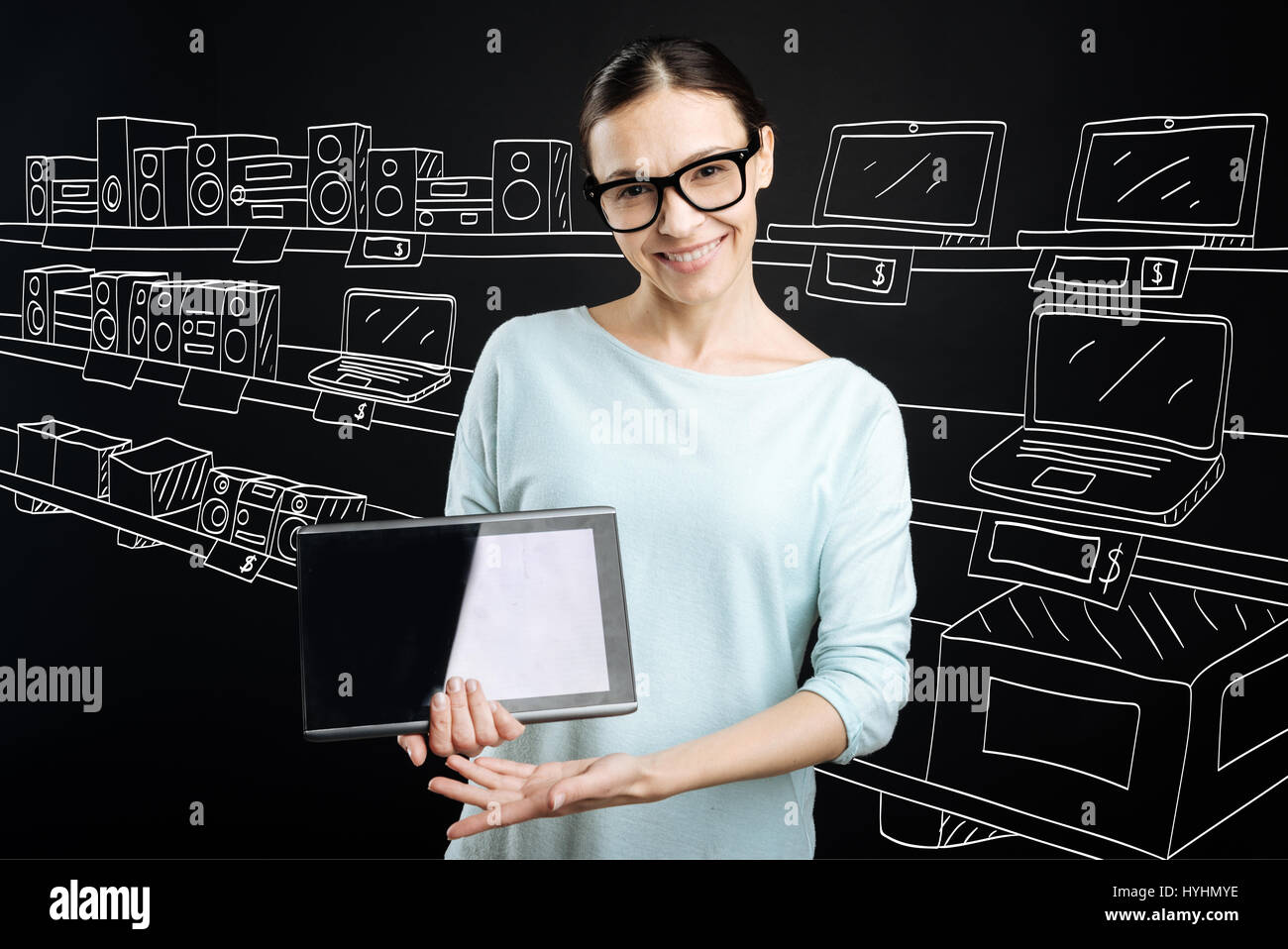Positive shop assistant selling electronics Stock Photo - Alamy
