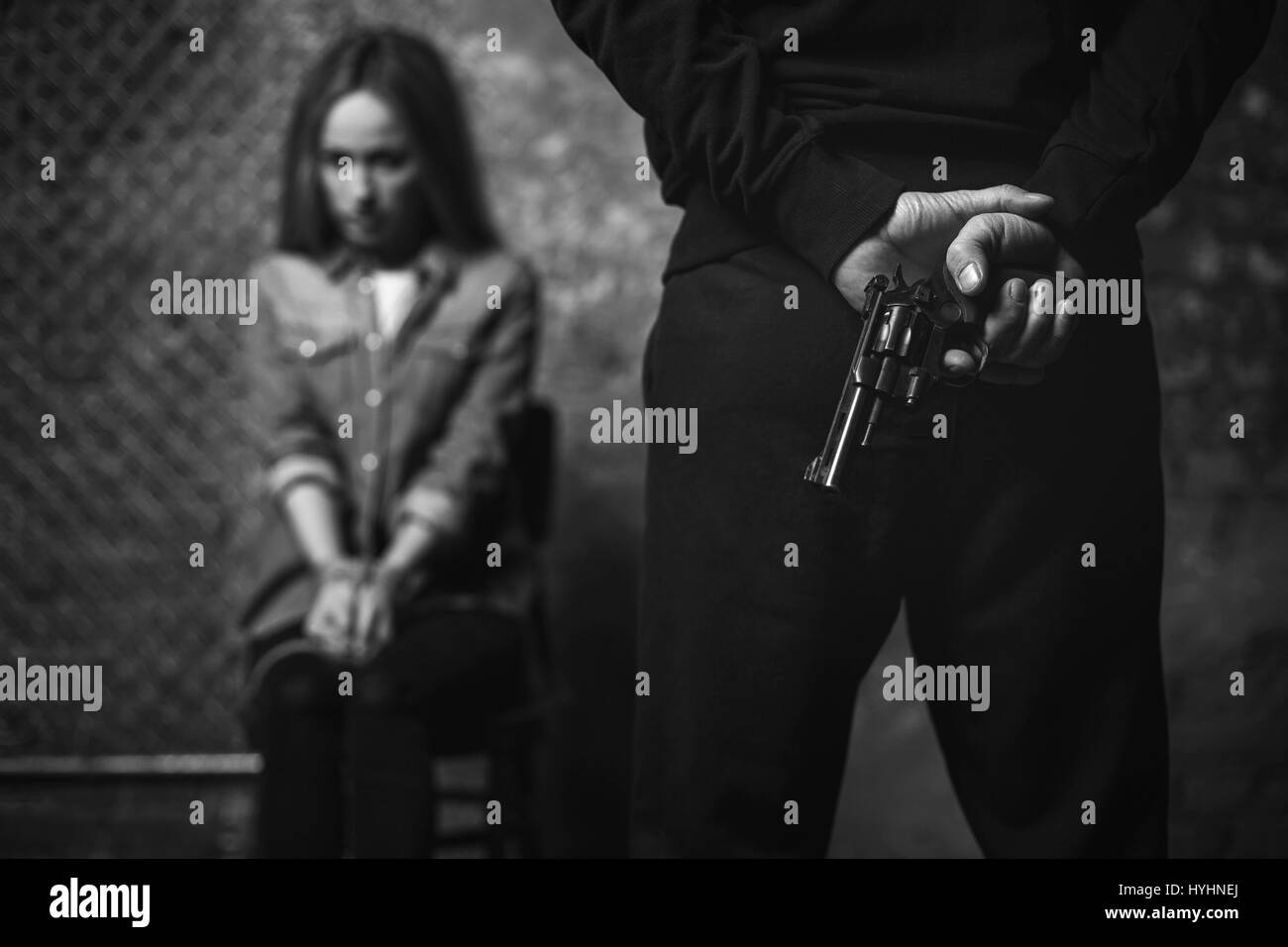 Destructive brutal villain watching over his victim Stock Photo - Alamy