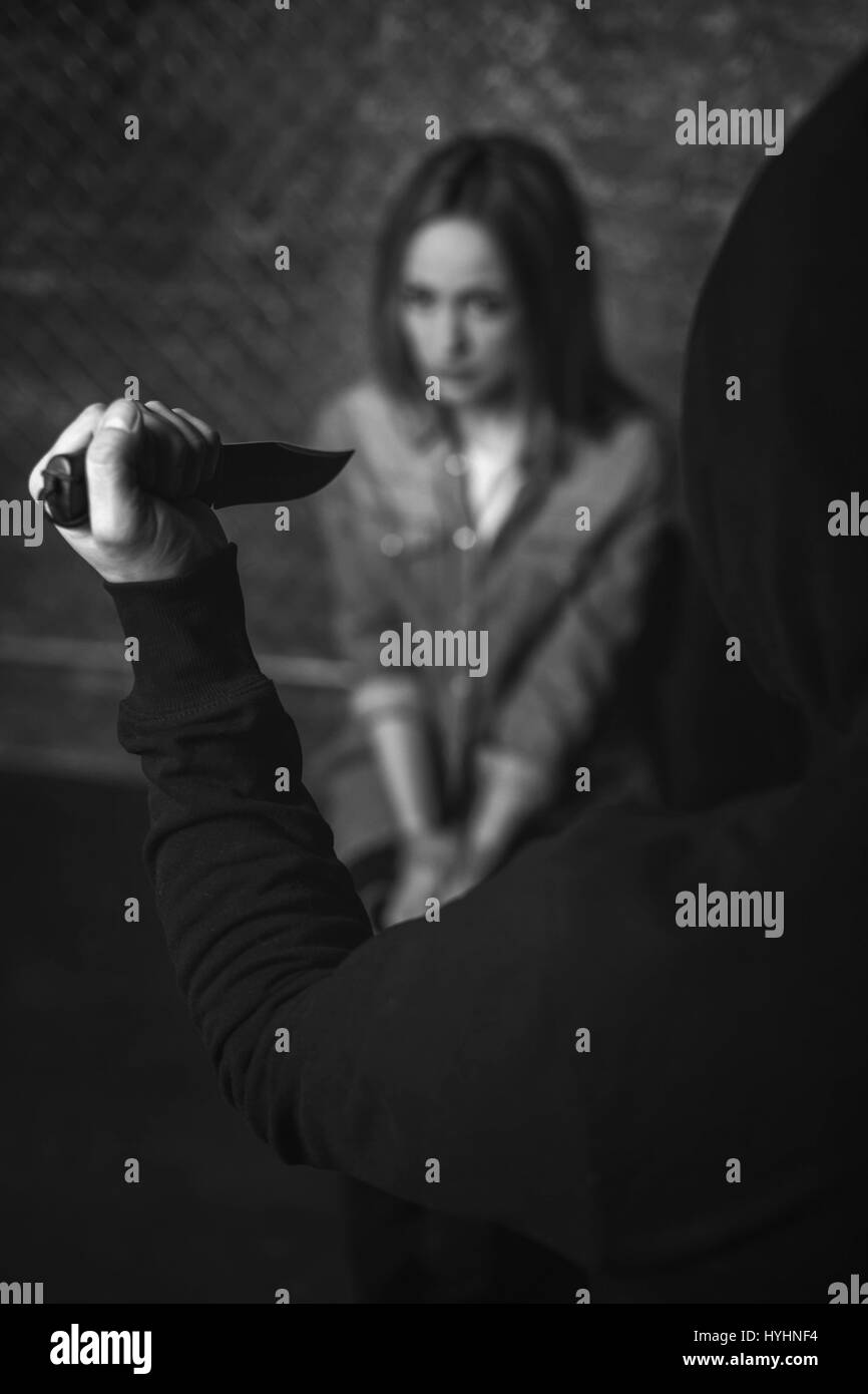 Barbaric evil abductor raising a knife Stock Photo - Alamy