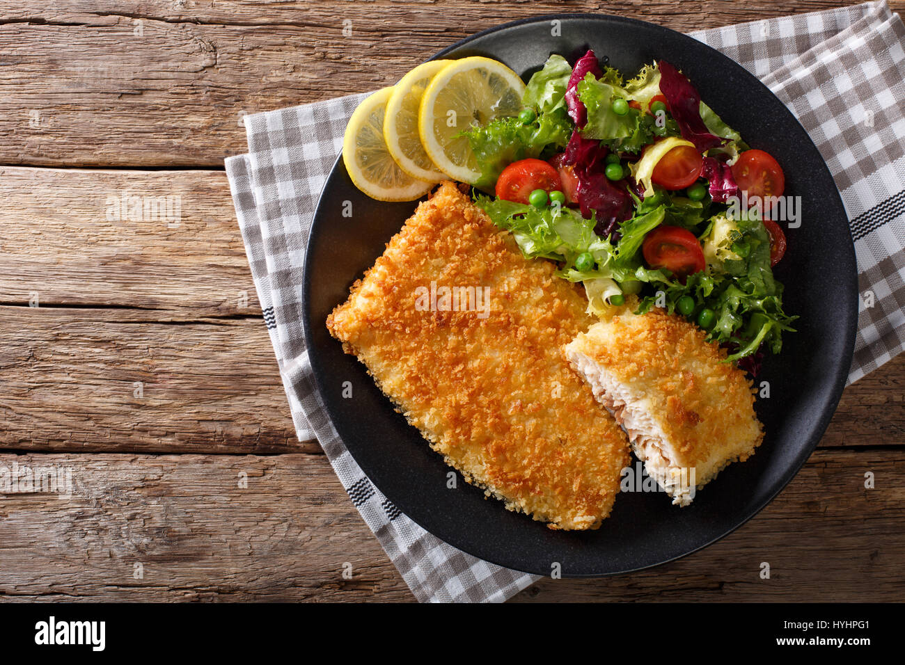 Fried Arctic char fish fillet in breadcrumbs and fresh vegetable salad ...