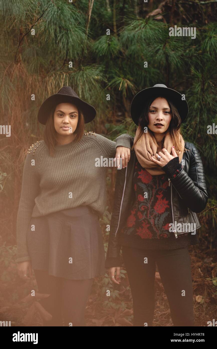 Young ethnic girls in hats modeling in front of trees Stock Photo - Alamy