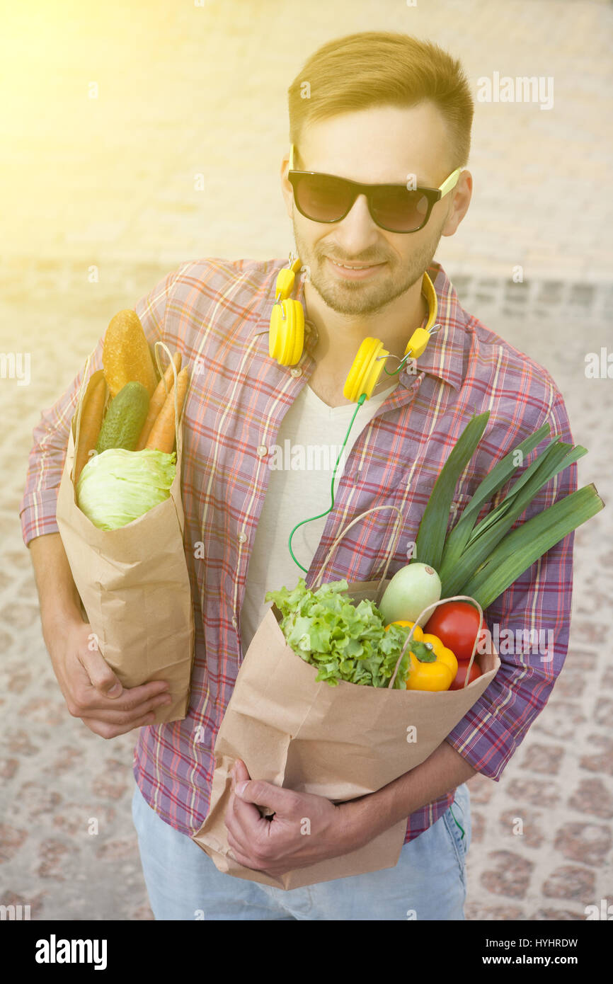 Young man with products Stock Photo - Alamy