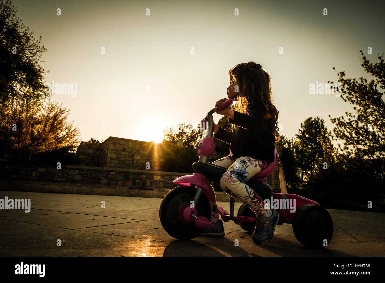 kid girl bike sunset Stock Photo - Alamy