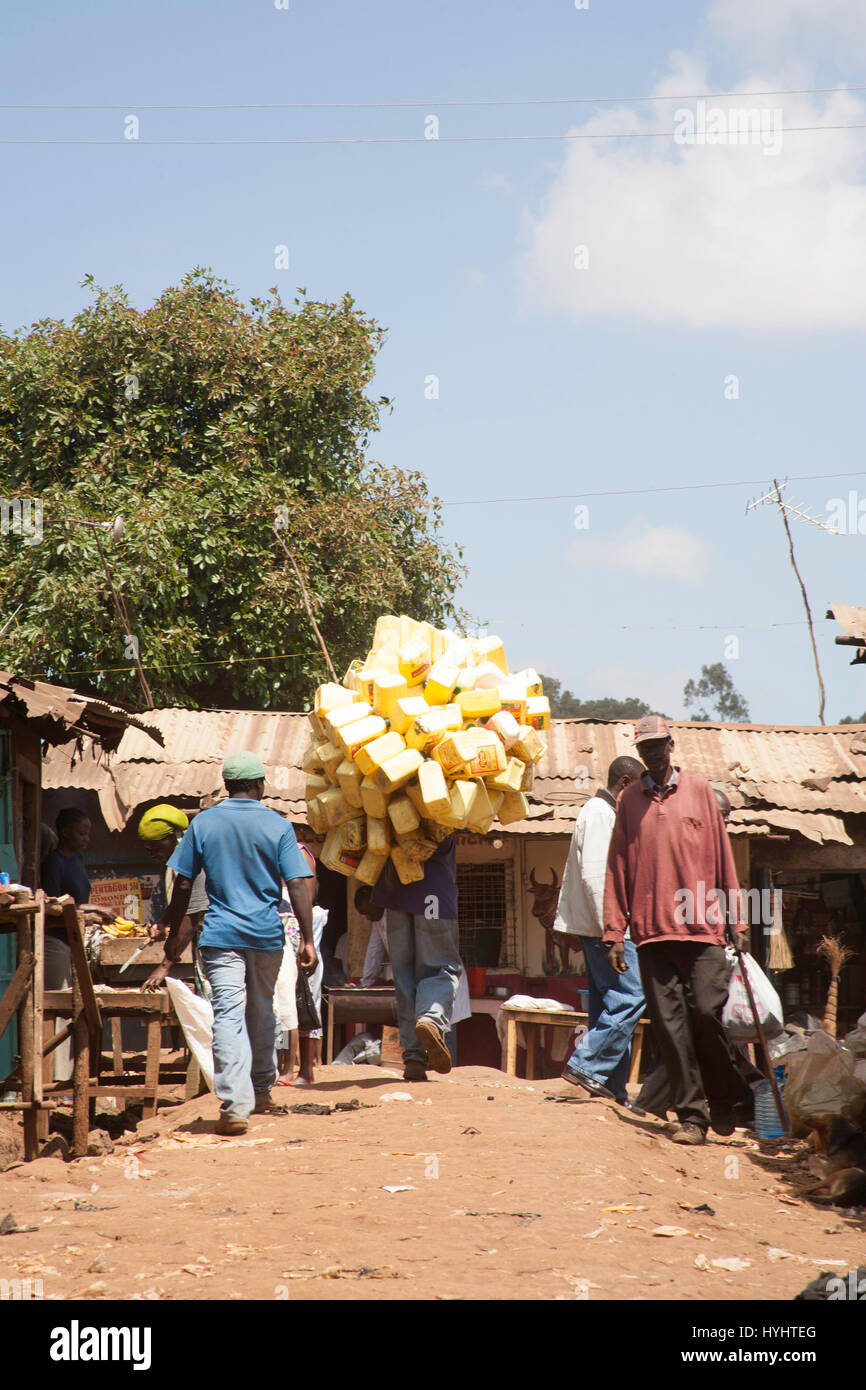 Someone carrying a lot of empty water containers through market, Kibera ...