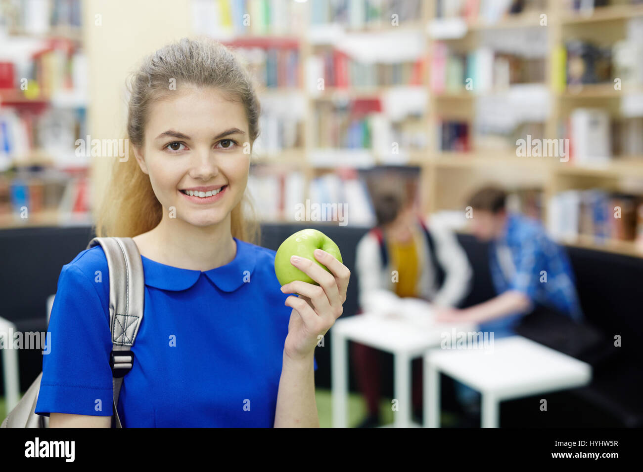 Smiling Blond Girl in Library of College Stock Photo - Alamy