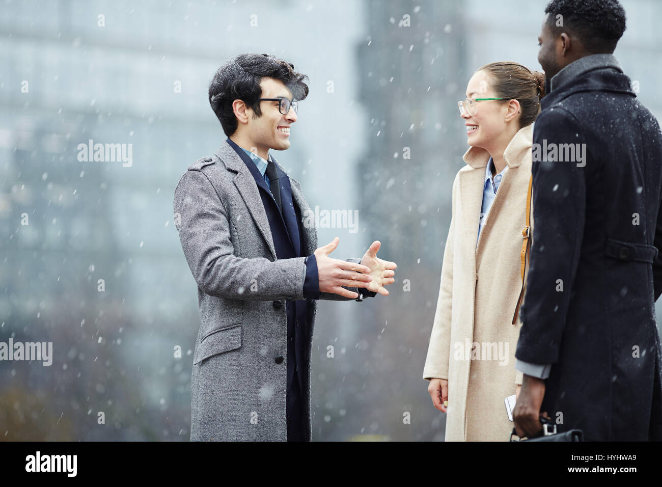 Business Colleagues Chatting in Snowy Street Stock Photo - Alamy