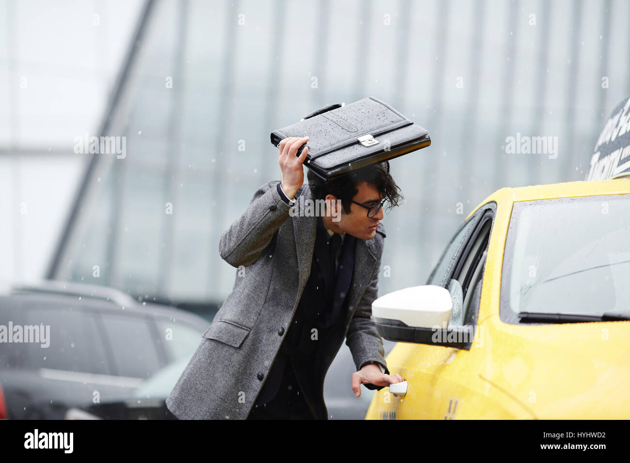 Businessman Catching Taxi in Storm Stock Photo - Alamy Businessman Catching Taxi in Storm Stock Photo - Alamy